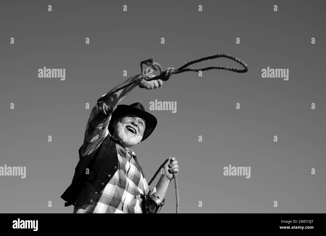 Old western cowboy with lasso rope. Bearded wild west man with brown ...