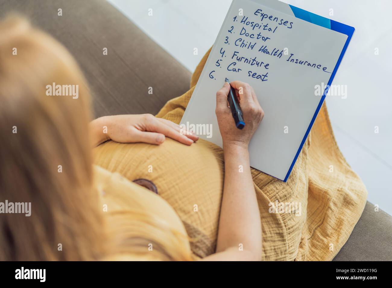 Expectant woman diligently compiles a list of childbirth costs ...