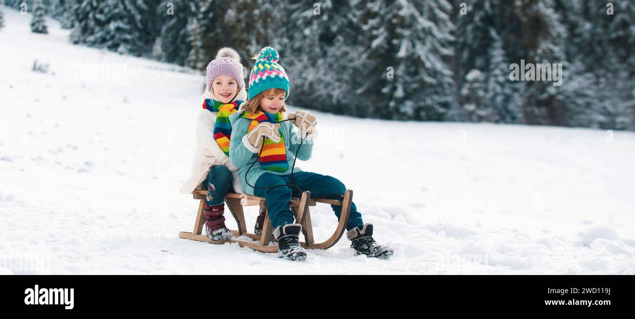 Friends children boy and girl sledding in winter. Kids sibling riding ...