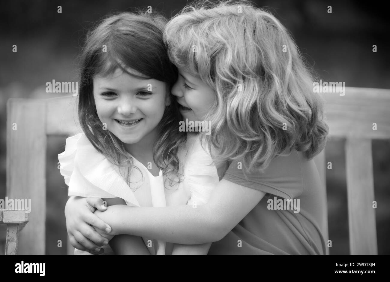 Child boy and girl hugging each other with love in the spring garden ...