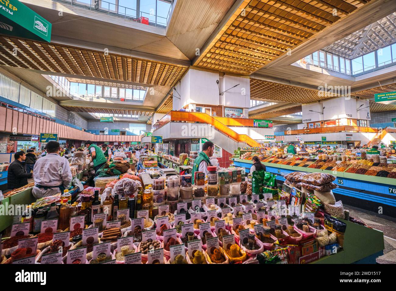 A vendor selling dried fruit, nuts and many spices, herbs, seasonings ...
