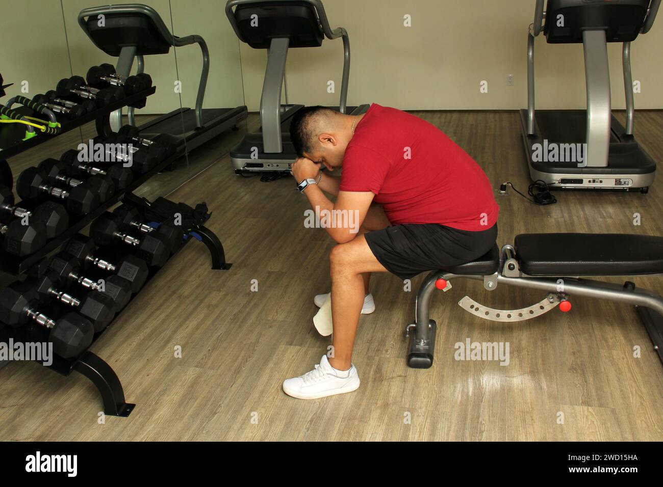 Dark-skinned Latino adult man suffers from muscle fatigue, tiredness ...