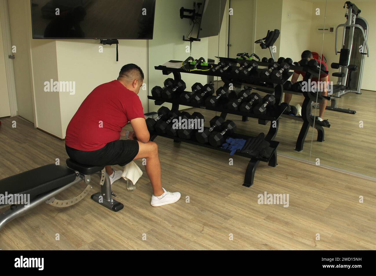 Dark-skinned Latino adult man suffers from muscle fatigue, tiredness ...