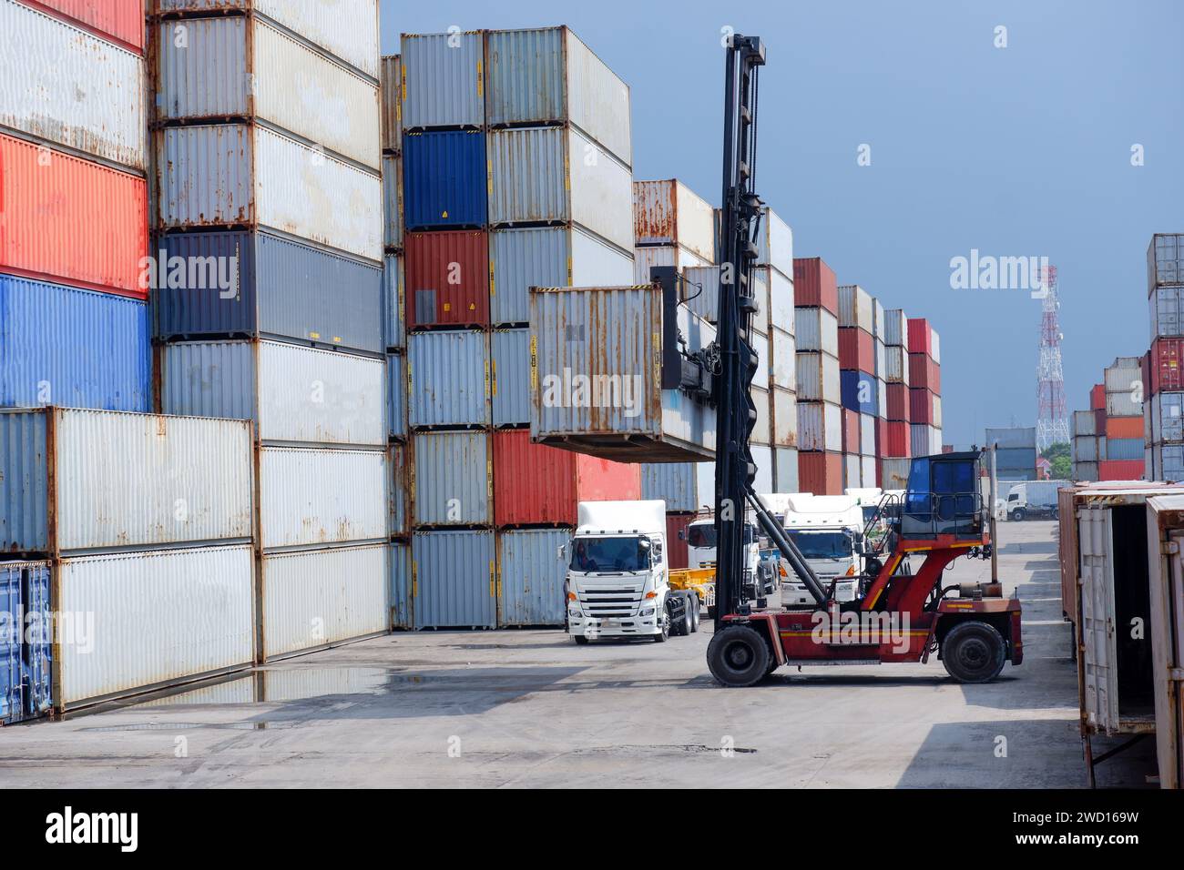 Container truck in a shipping yard with stacks of colorful containers ...