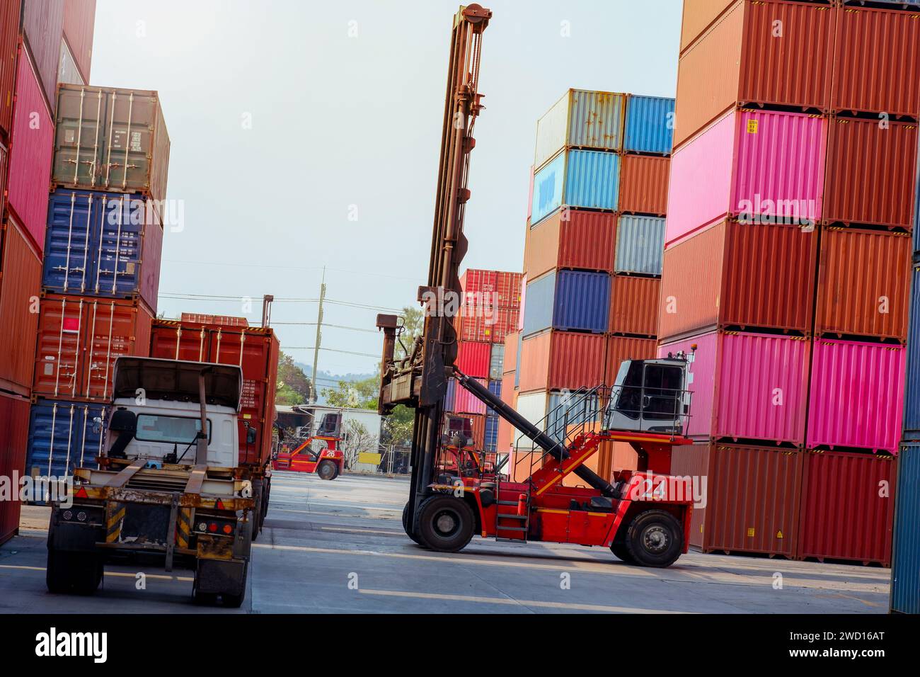 Container truck in a shipping yard with stacks of colorful containers ...