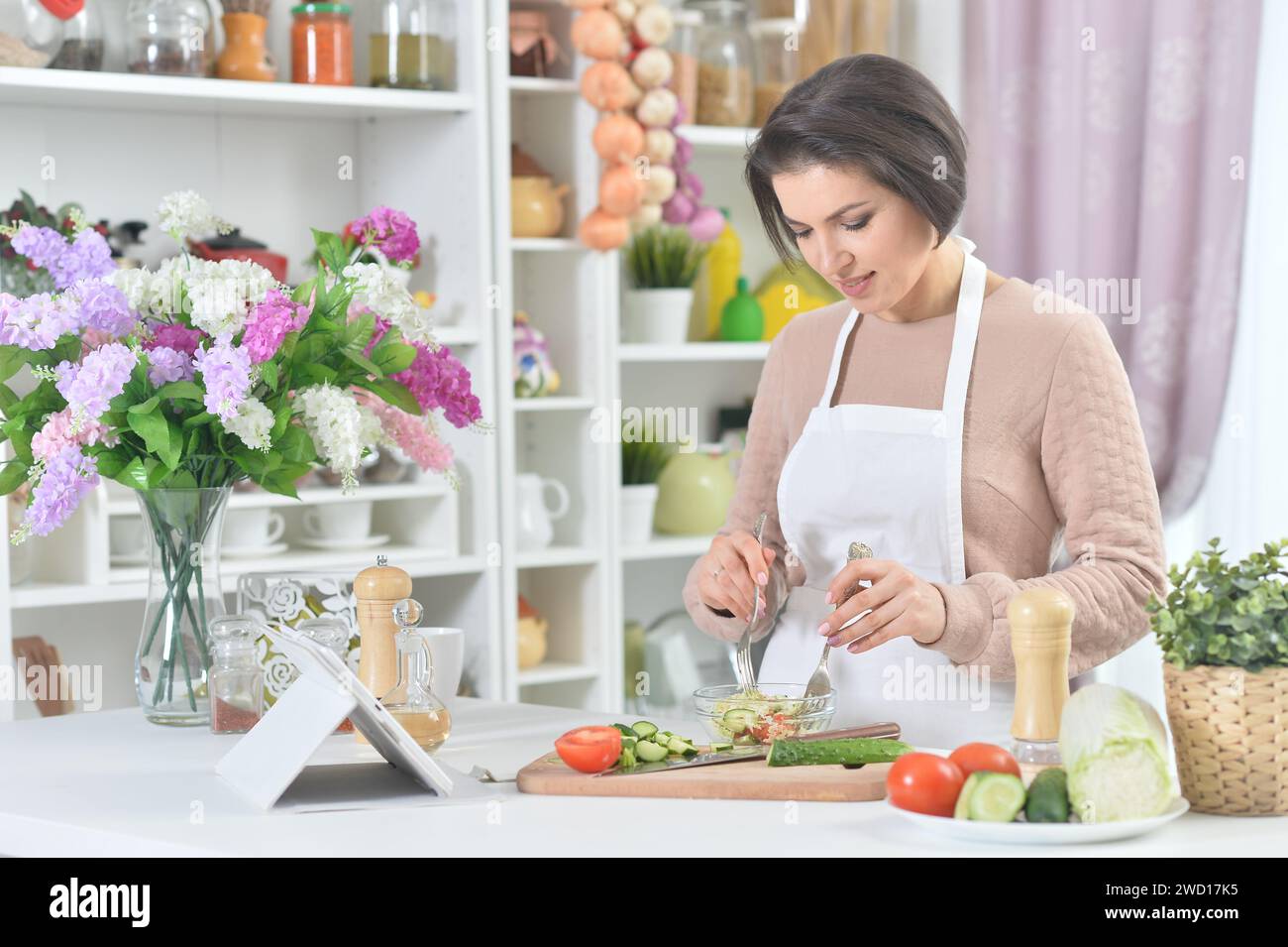 Portrait of a beautiful woman cooking at kitchen Stock Photo - Alamy