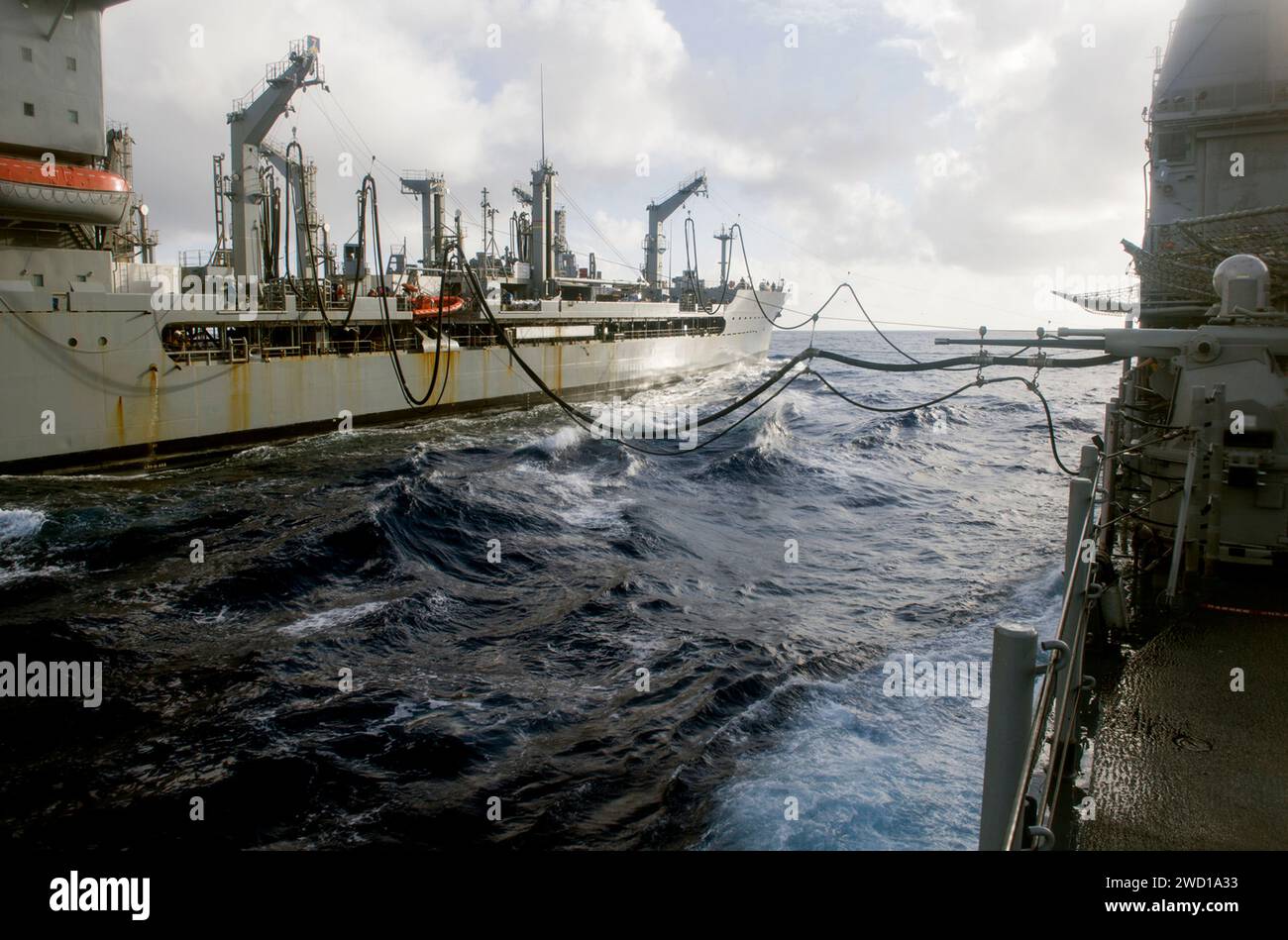 USNS Guadalupe pumps fuel to the guided-missile cruiser USS Lake ...