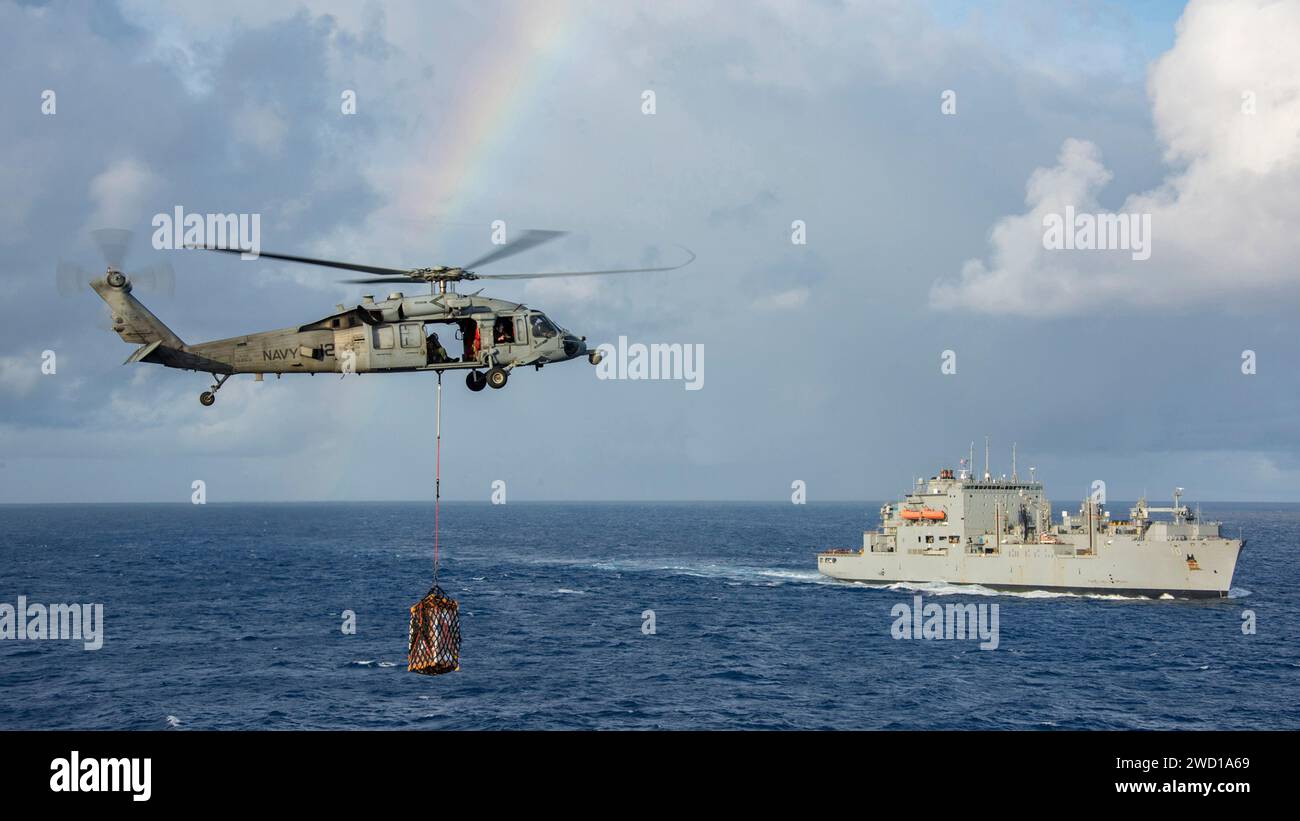 An MH-60S Sea Hawk transfers cargo from USNS Charles Drew to USS Carl ...
