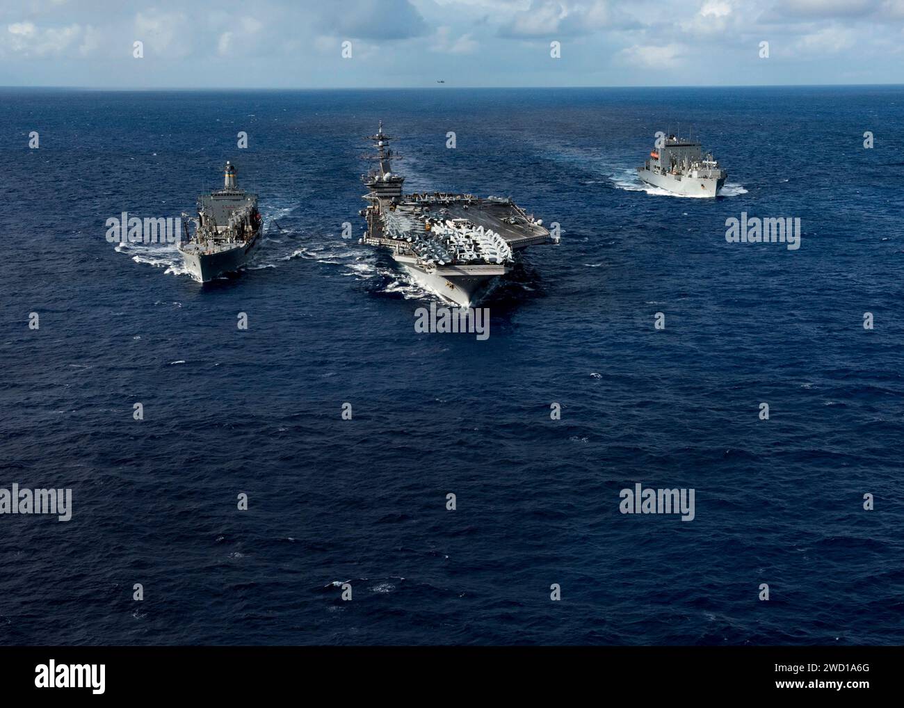USS Carl Vinson in a dual replenishment-at-sea with USNS Pecos and USNS ...