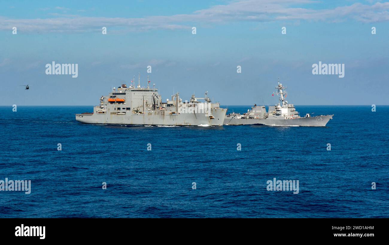 USS Wayne E. Meyer (right), conducts a replenishment-at-sea with USNS ...