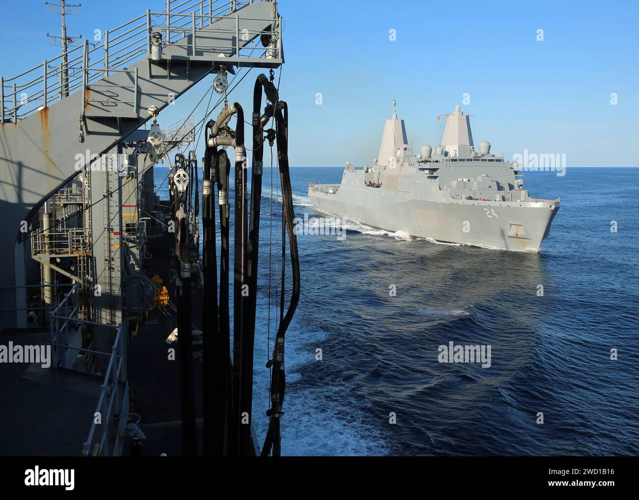 USS Arlington pulls along-side the fast combat support ship USNS Arctic ...