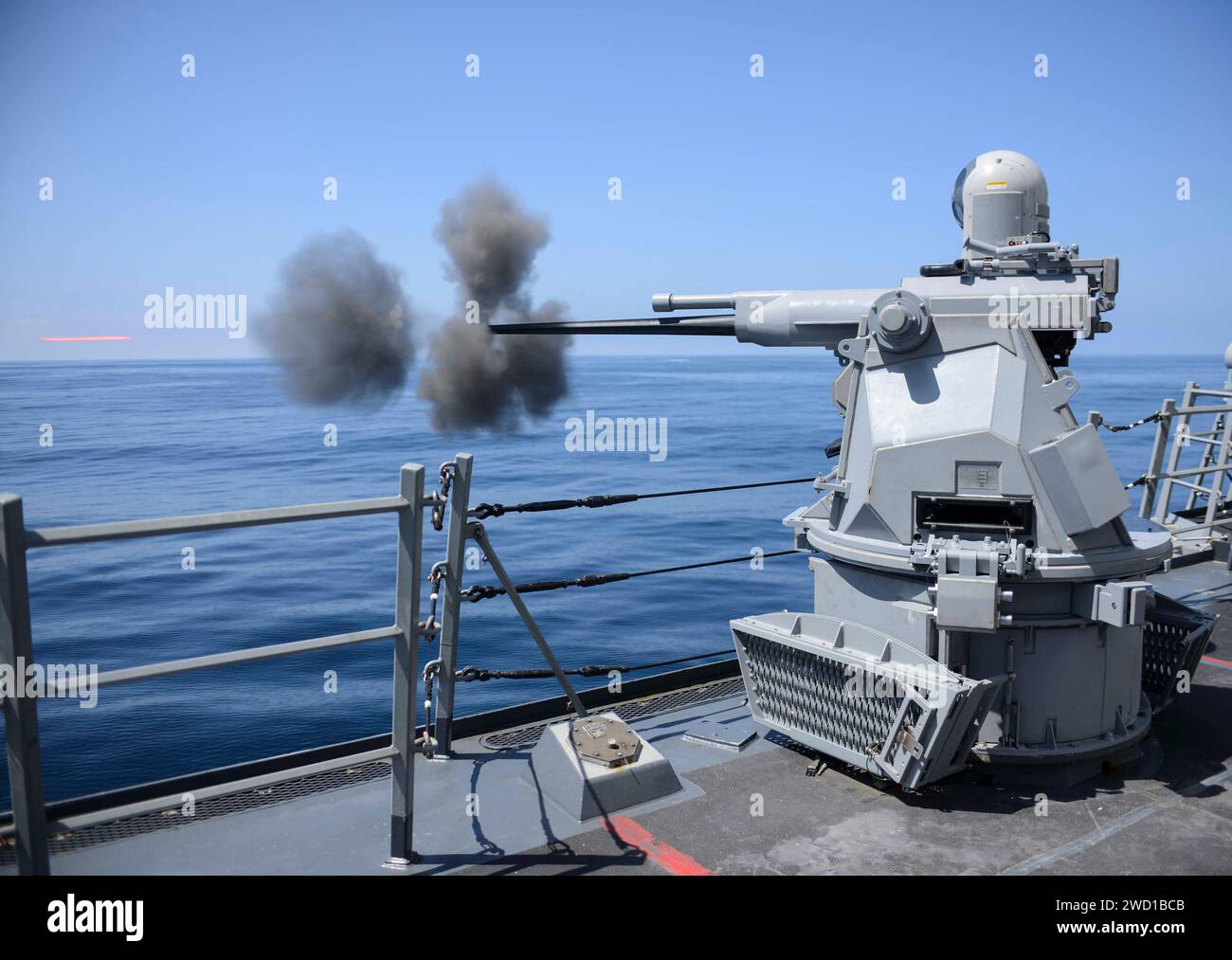 Guided-missile destroyer USS Kidd fires its Mark 38 25mm machine gun ...
