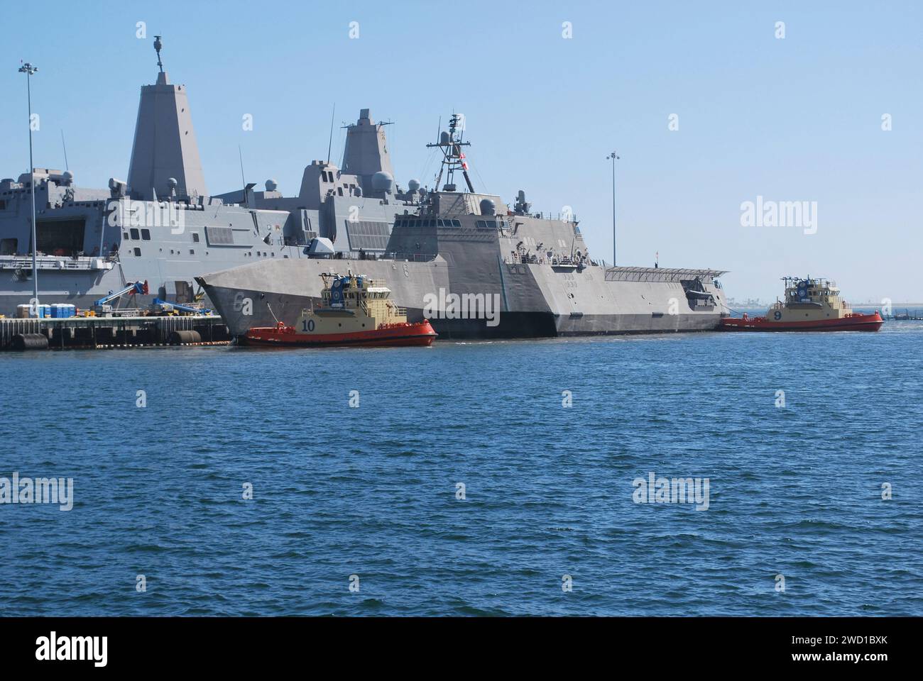 Tug boats moor the Independence-variant littoral combat ship USS ...