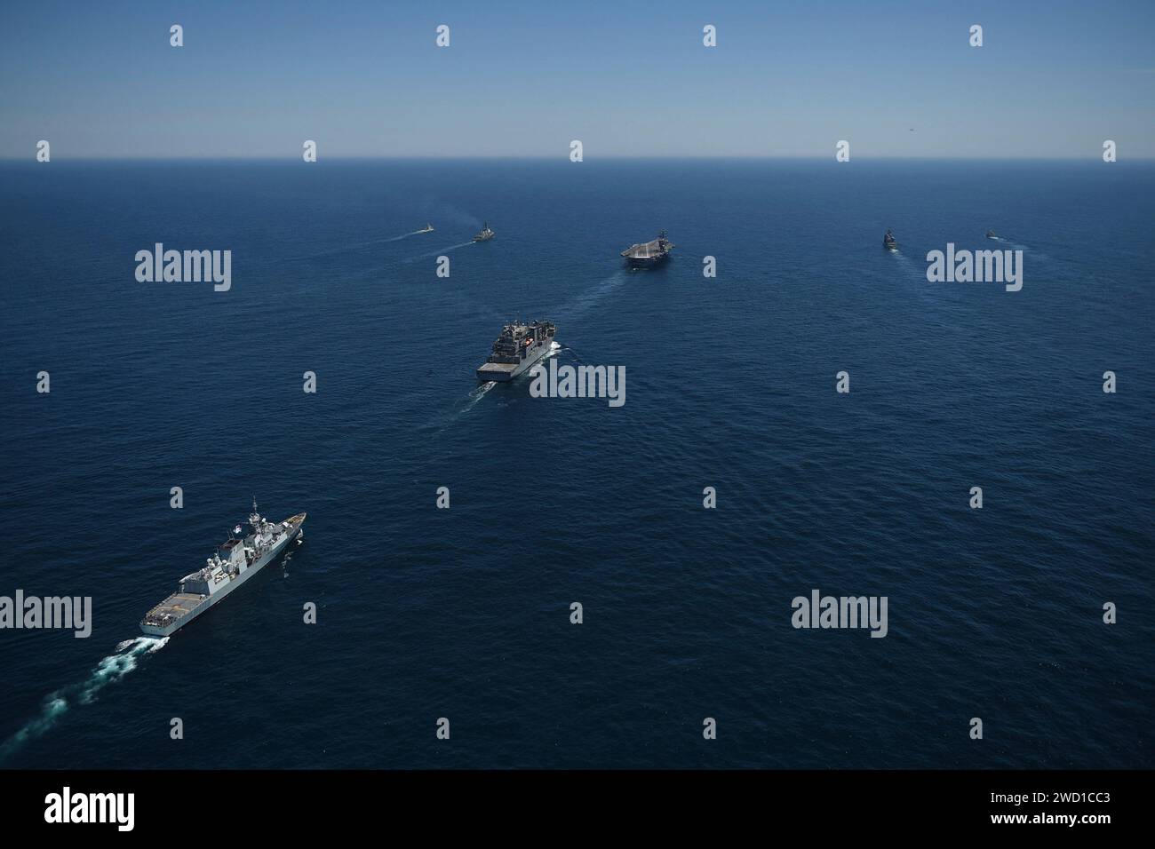 A fleet of U.S. Navy ships and Royal Canadian Navy ships transit the ...