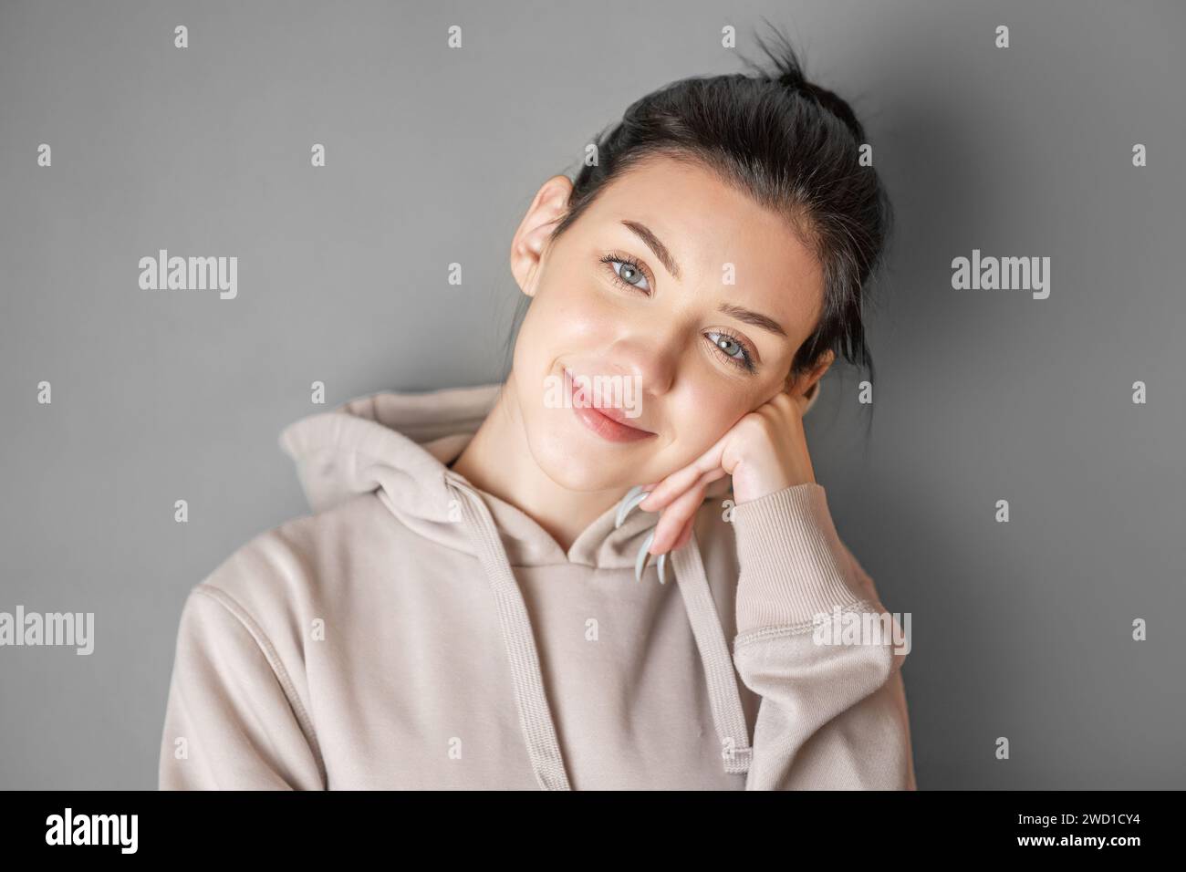 Portrait of a young pretty smoling girl in a hoodie Stock Photo - Alamy