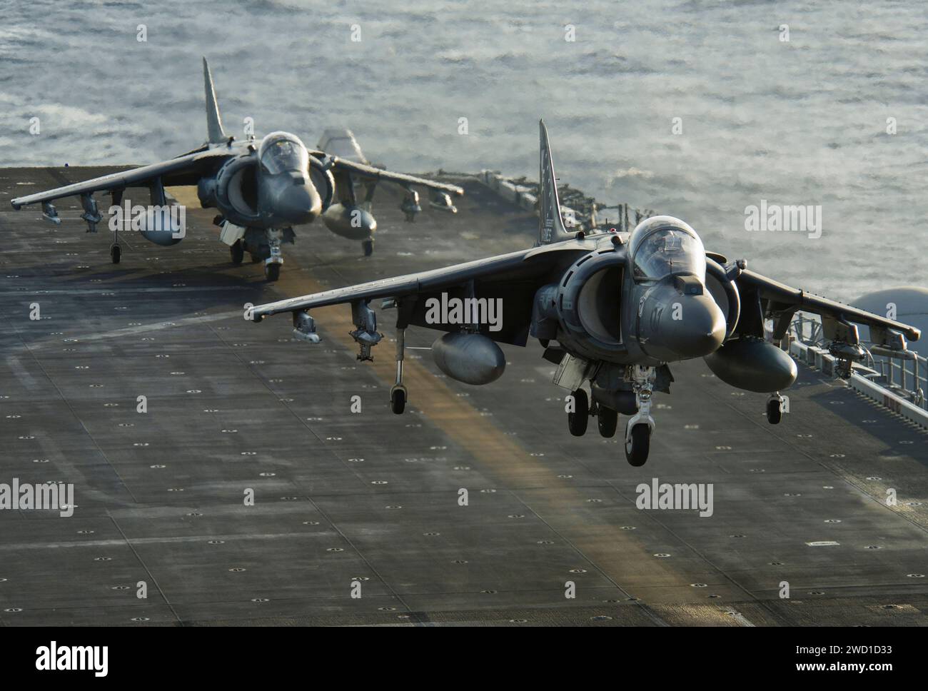 An AV-8B Harrier lands on the flight deck of USS America during flight ...