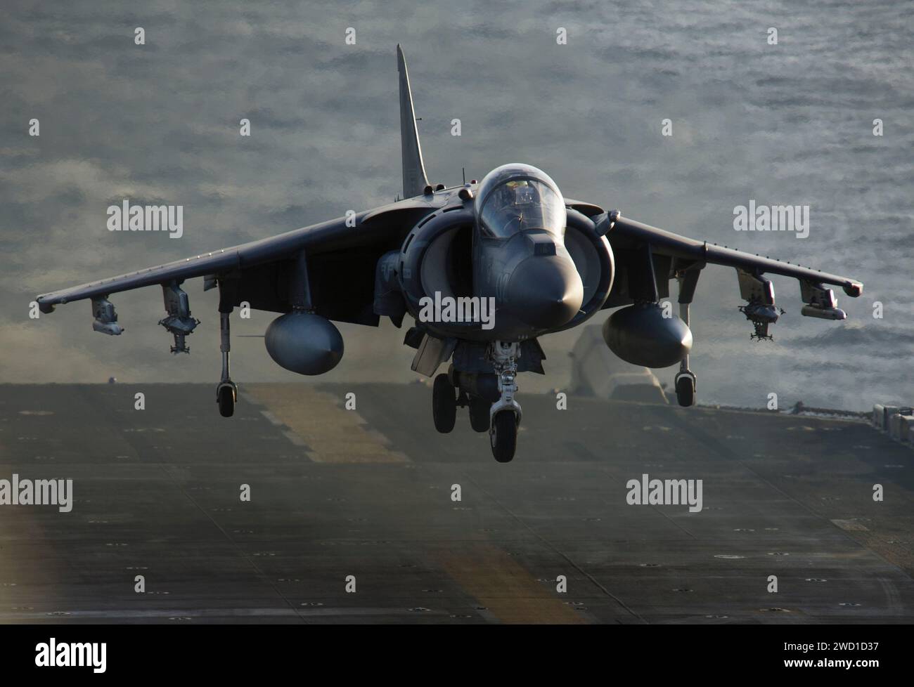 An AV-8B Harrier lands on the flight deck of USS America during flight ...