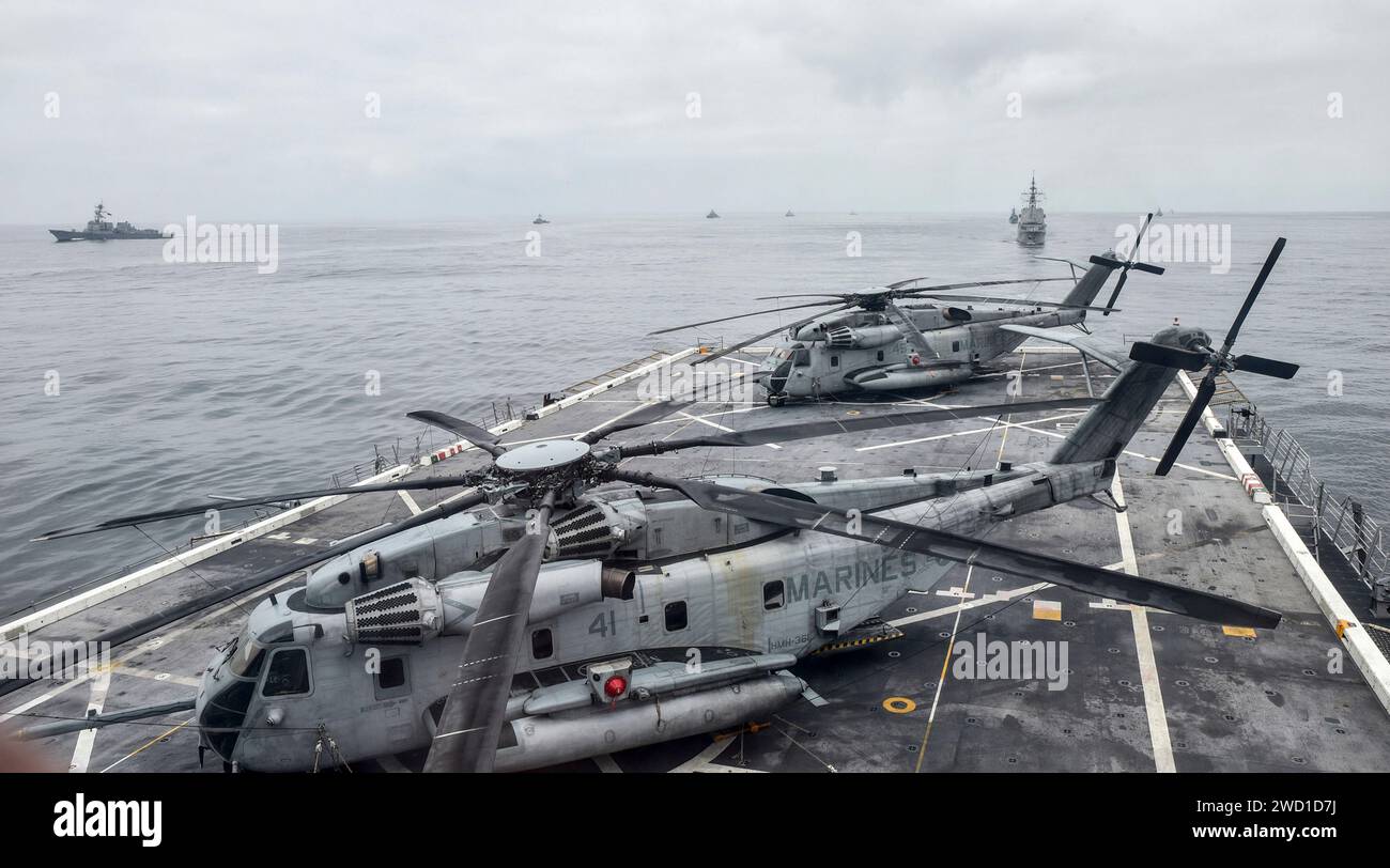 Ships sail in formation with the amphibious transport dock ship USS ...