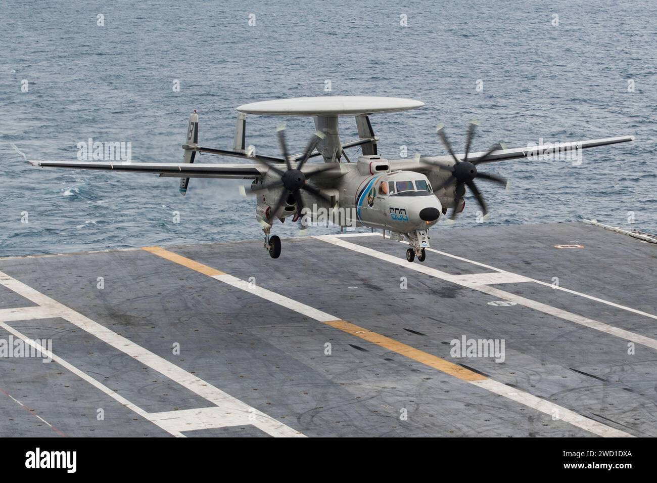 An E-2D Hawkeye early warning and attack aircraft landing on the flight ...