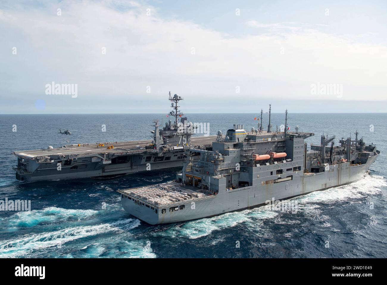USS Harry S. Truman conducts an ammunition onload with the dry cargo ...