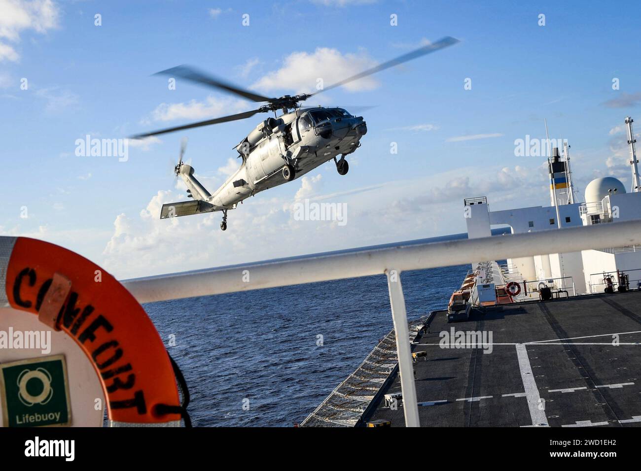 An MH-60S Sea Hawk helicopter prepares to land aboard the hospital ship ...