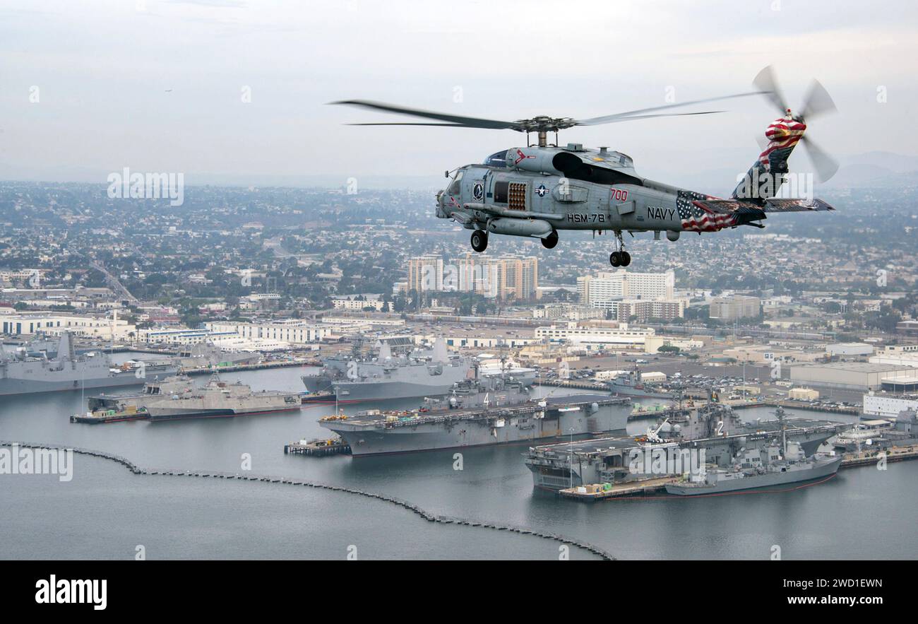 An MH-60R Sea Hawk helicopter flies over San Diego Bay, California ...