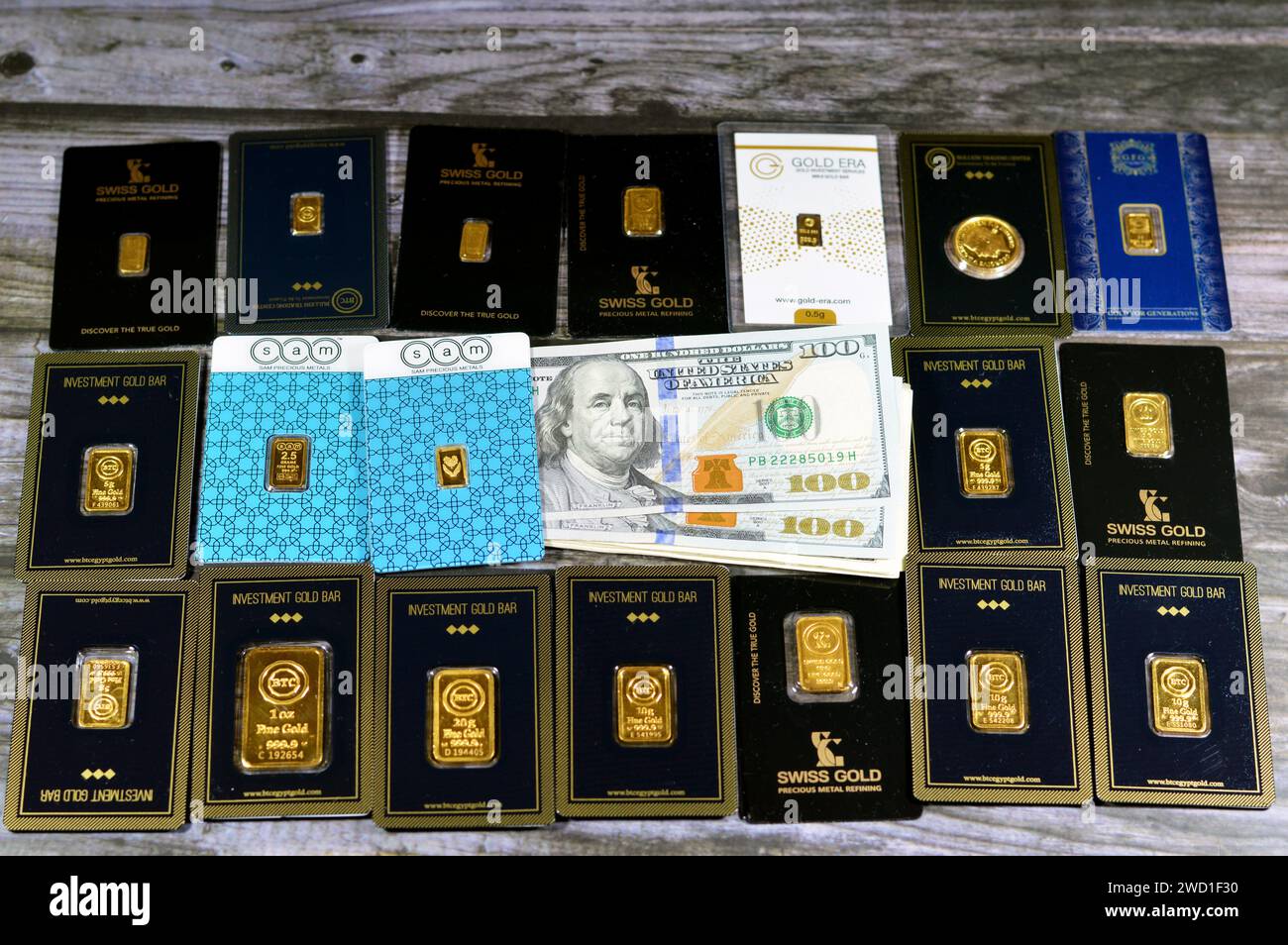 Cairo, Egypt, January 15 2024: American dollars money and pile of 24K ...