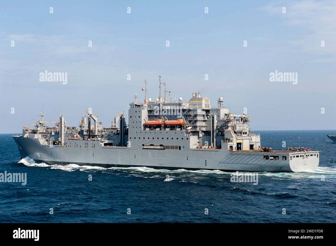 The dry cargo and ammunition ship USNS Alan Shepard transits the ...