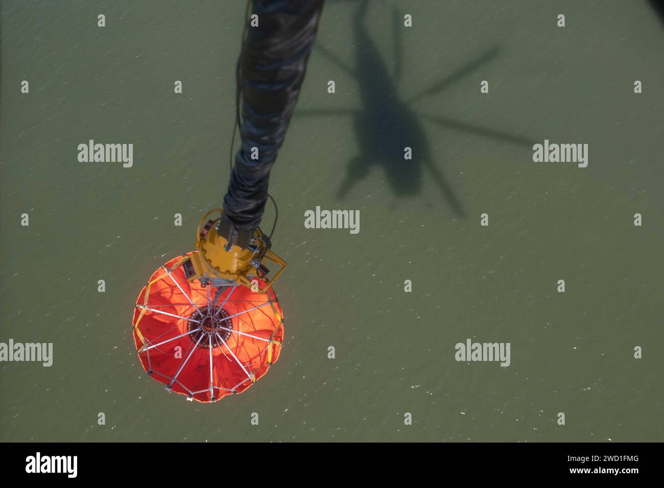 An MH-53E Sea Dragon helicopter utilizes a Bambi Bucket to conduct ...