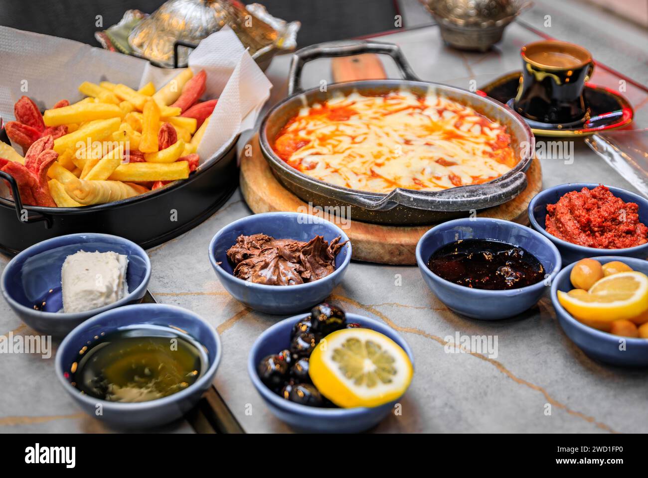 Traditional Turkish breakfast kahvalti with eggs in a skillet, jams ...
