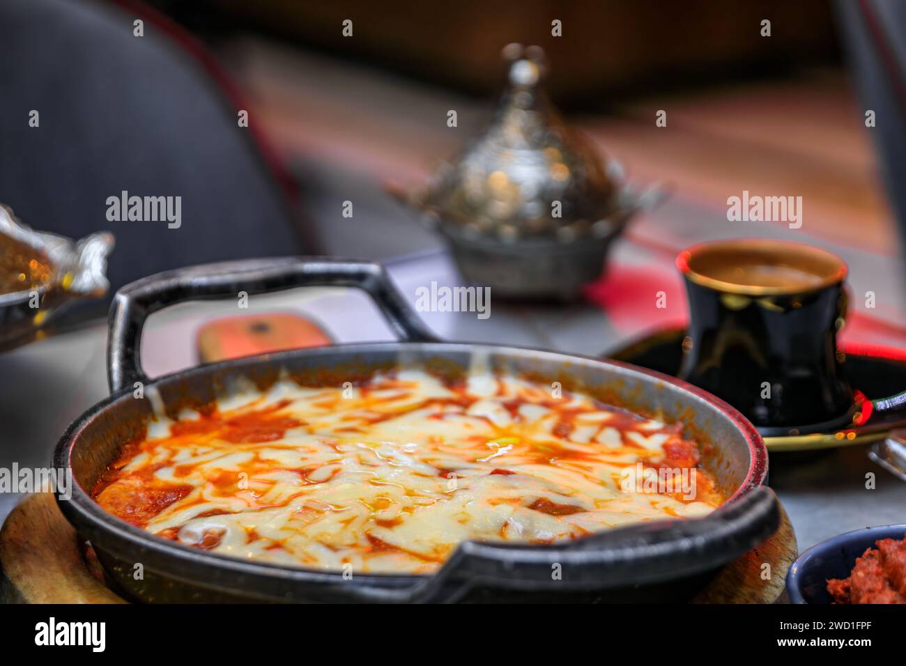 Traditional Turkish breakfast kahvalti with eggs in a skillet, jams ...