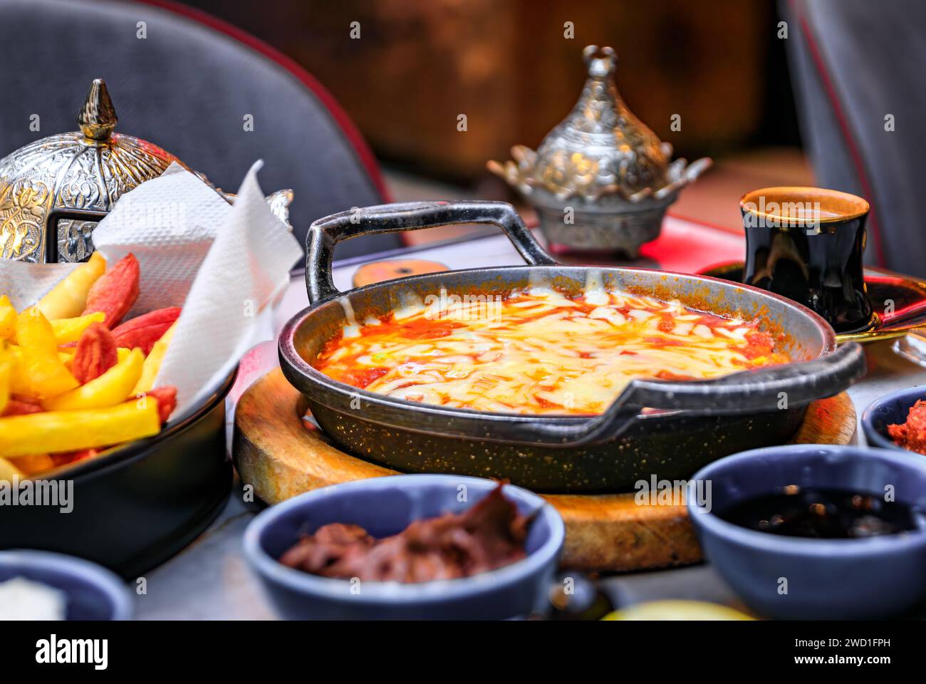Traditional Turkish breakfast kahvalti with eggs in a skillet, jams ...