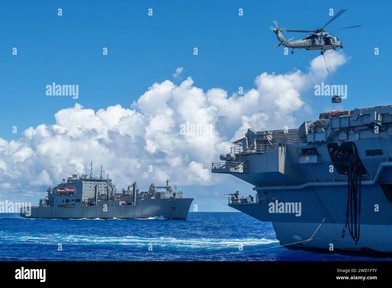 An MH-60S Sea Hawk carries cargo from USNS Alan Shephard to USS Ronald ...