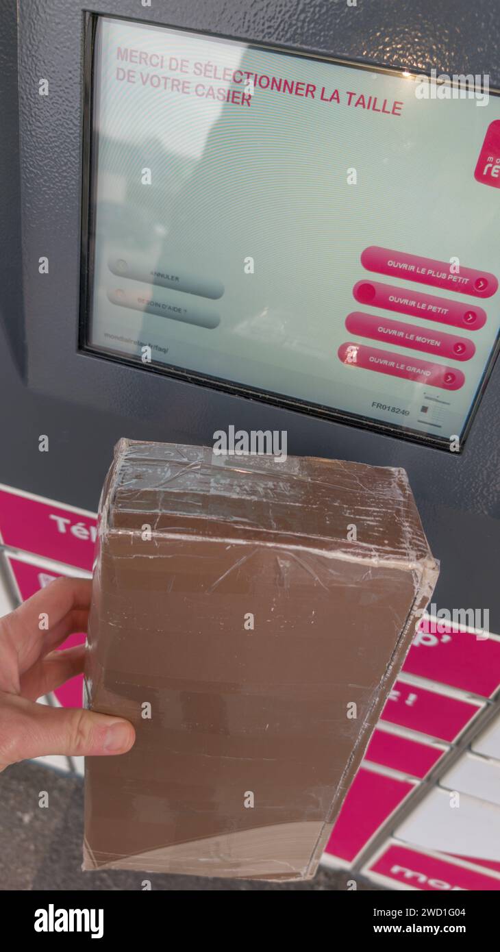 Bordeaux , France - 01 14 2024 : mondial relay screen and hand man ...