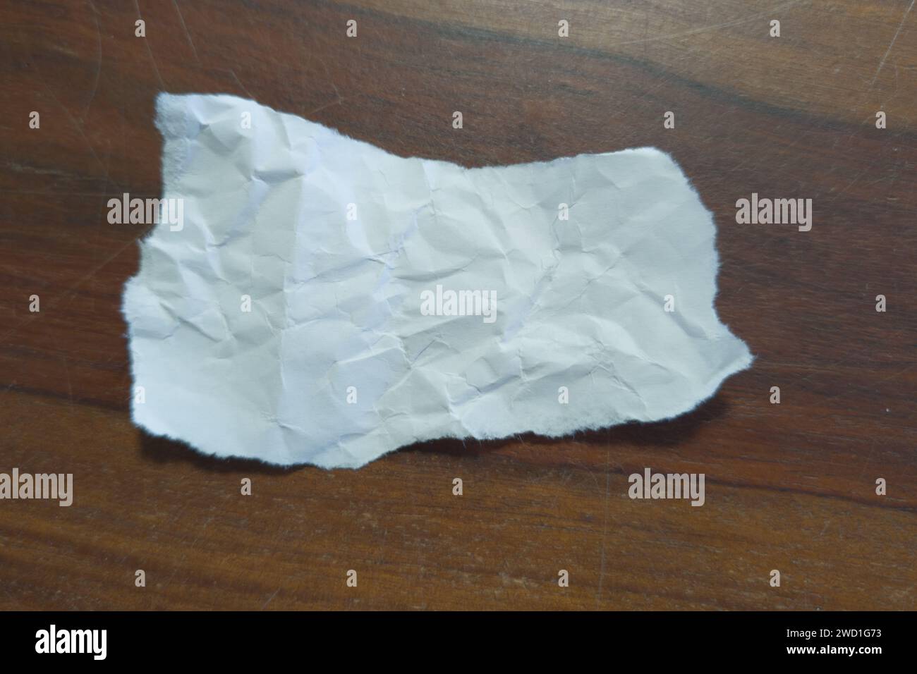 Blank torn paper isolated on brown background in top view of white ...