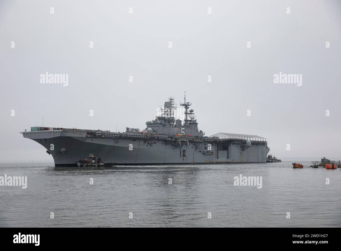 The amphibious assault ship USS Bataan departs Naval Station Norfolk ...