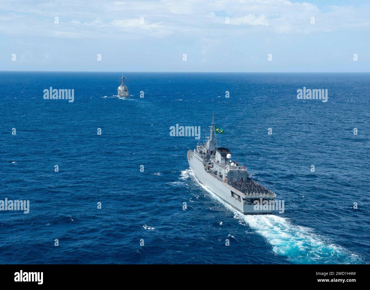 The Brazilian Navy training ship BNS Brasil transits behind the guided ...