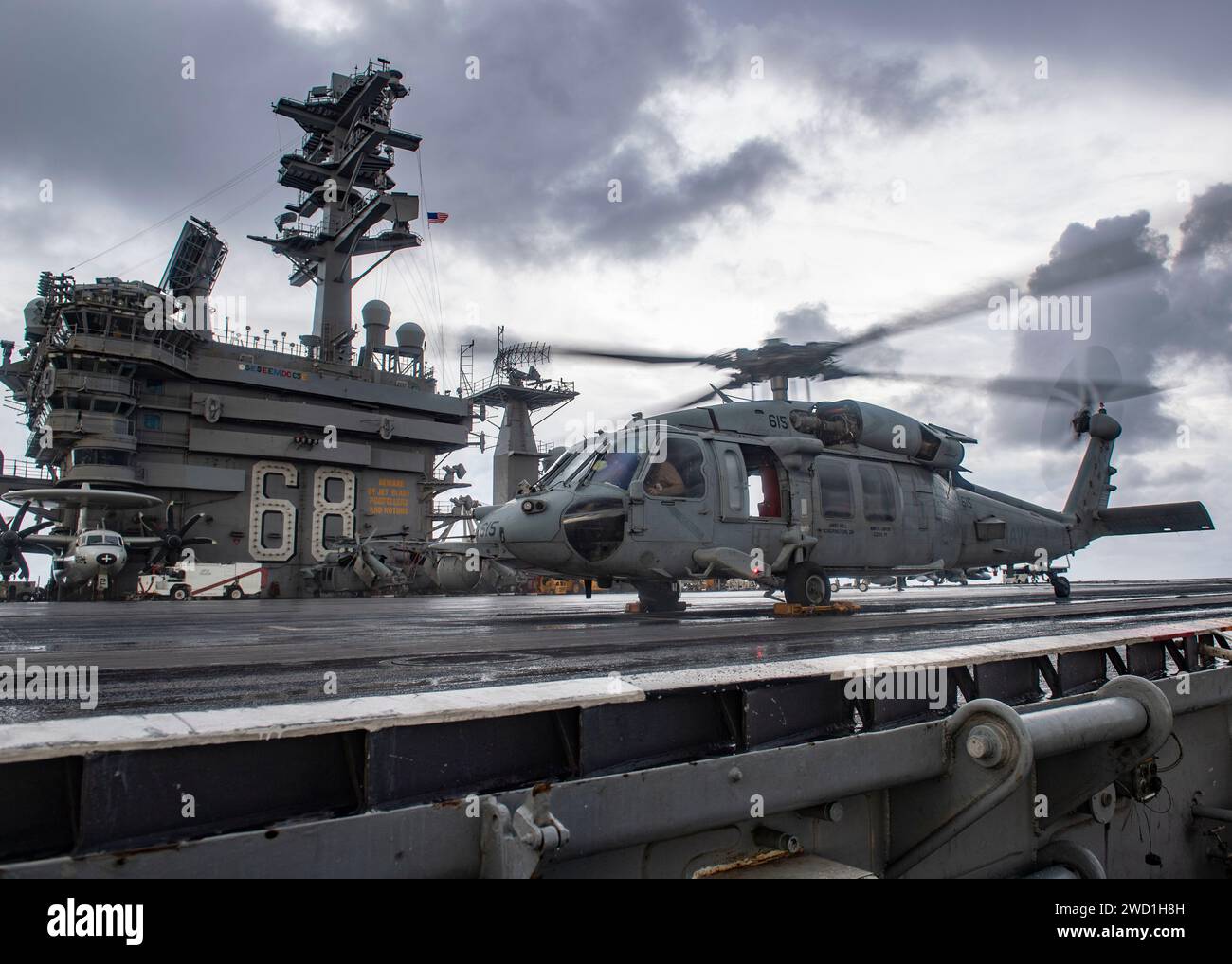 An MH-60S Sea Hawk helicopter conducts flight control checks on the ...