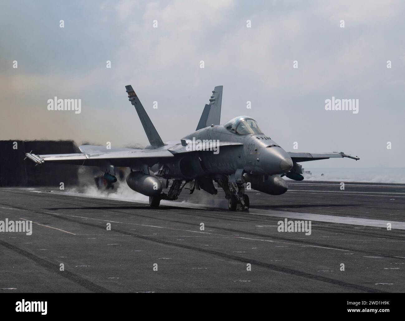 An F/A-18C Hornet launches off the flight deck of the aircraft carrier ...
