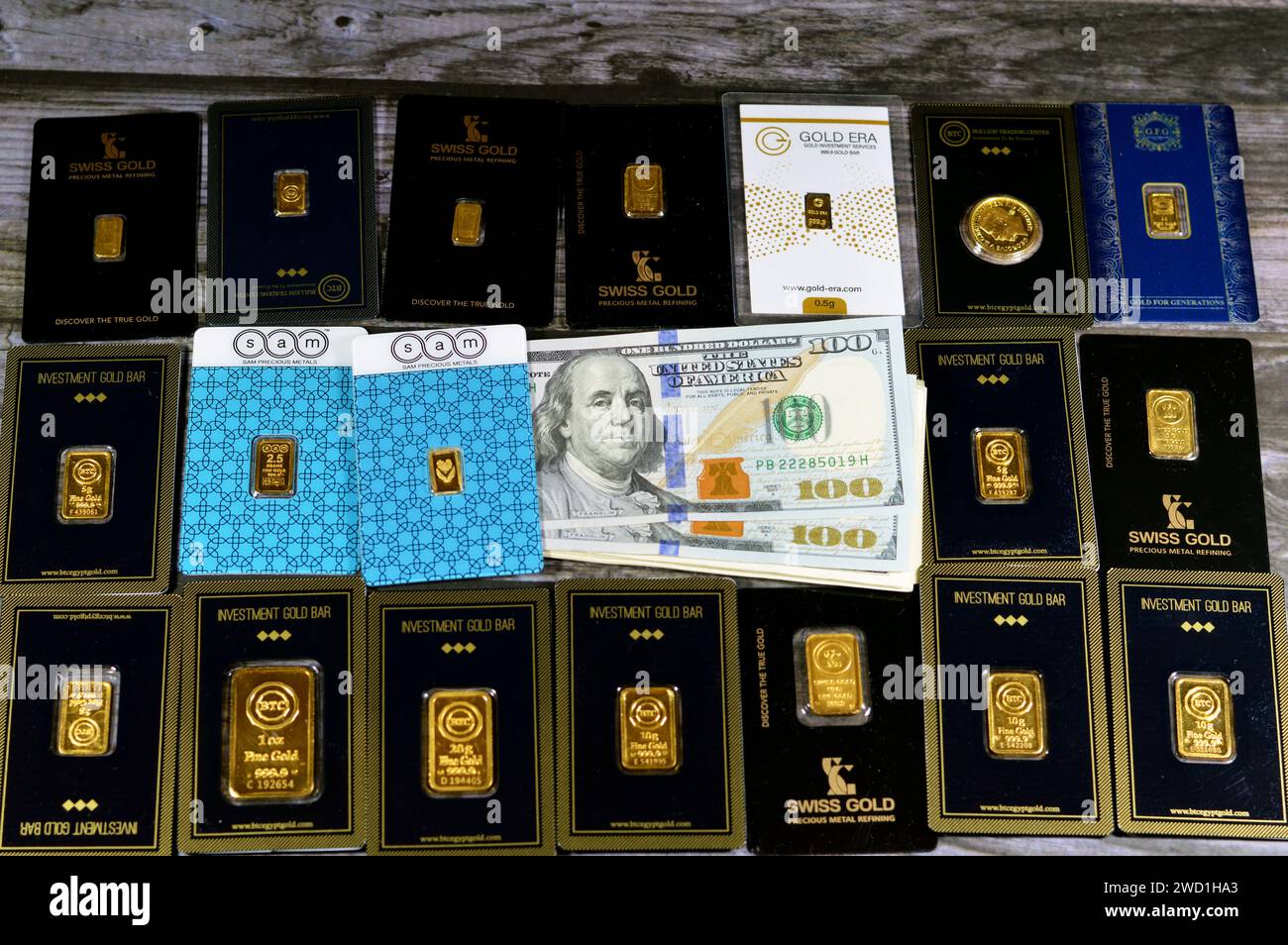Cairo, Egypt, January 15 2024: American dollars money and pile of 24K ...