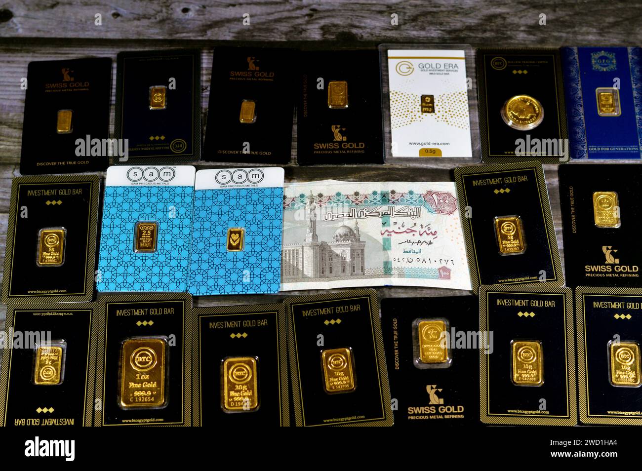 Cairo, Egypt, January 15 2024: Egyptian pounds money and pile of 24K ...