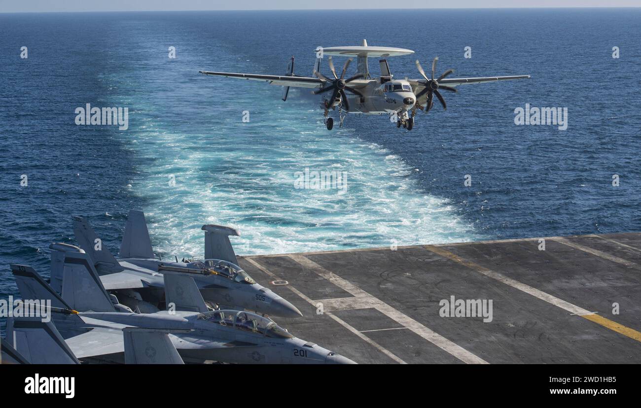 An E-2C Hawkeye approaches the flight deck of the aircraft carrier USS ...