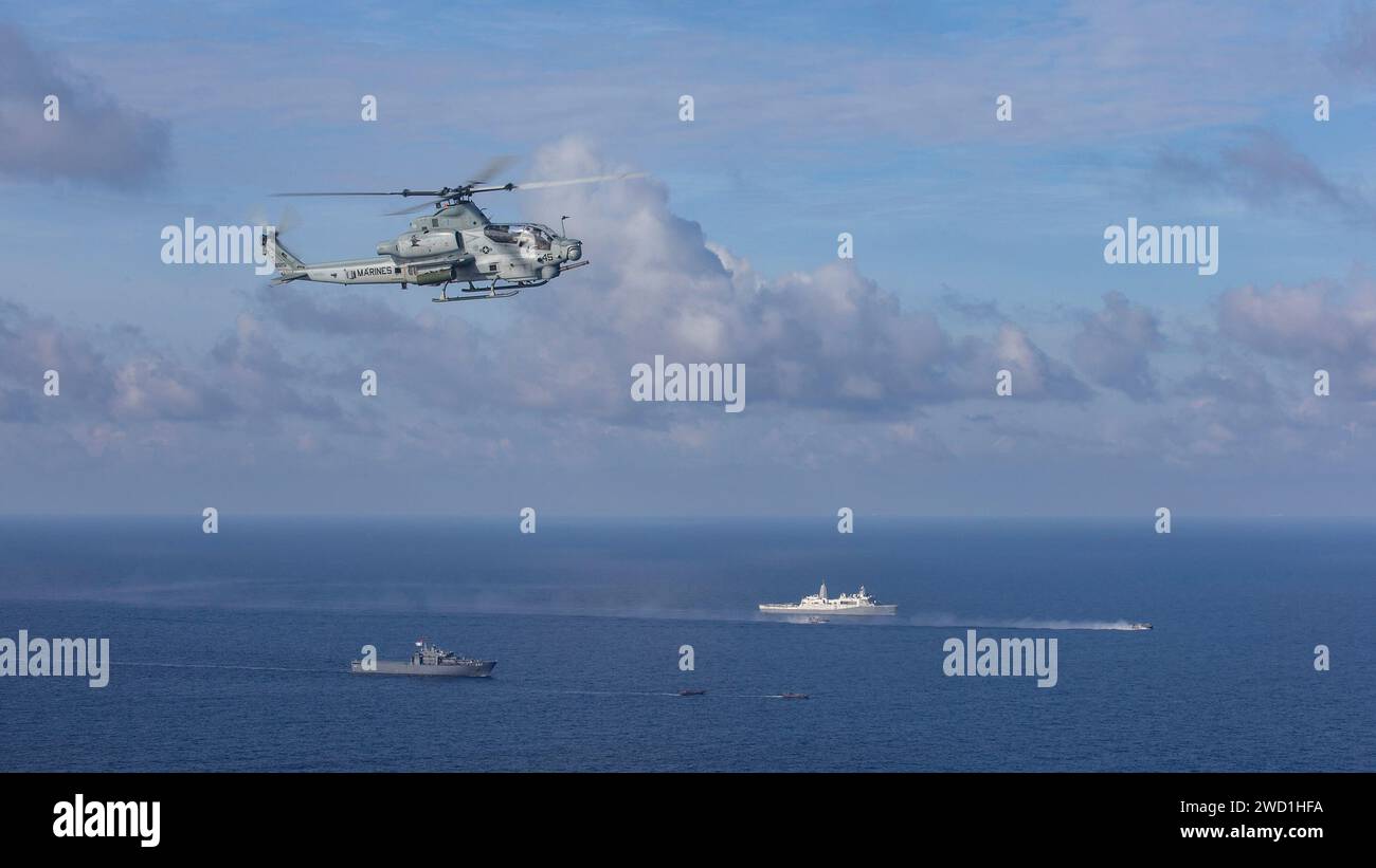 A U.S. Marine Corps AH-1Z Viper helicopter flies above U.S. Navy and ...