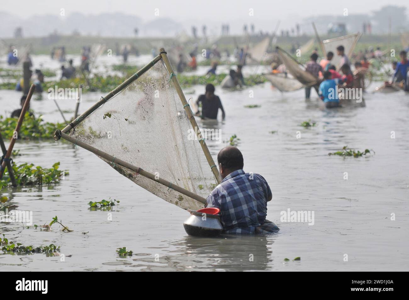 Rural people armed with Bamboo fish traps and handmade fishing nets ...