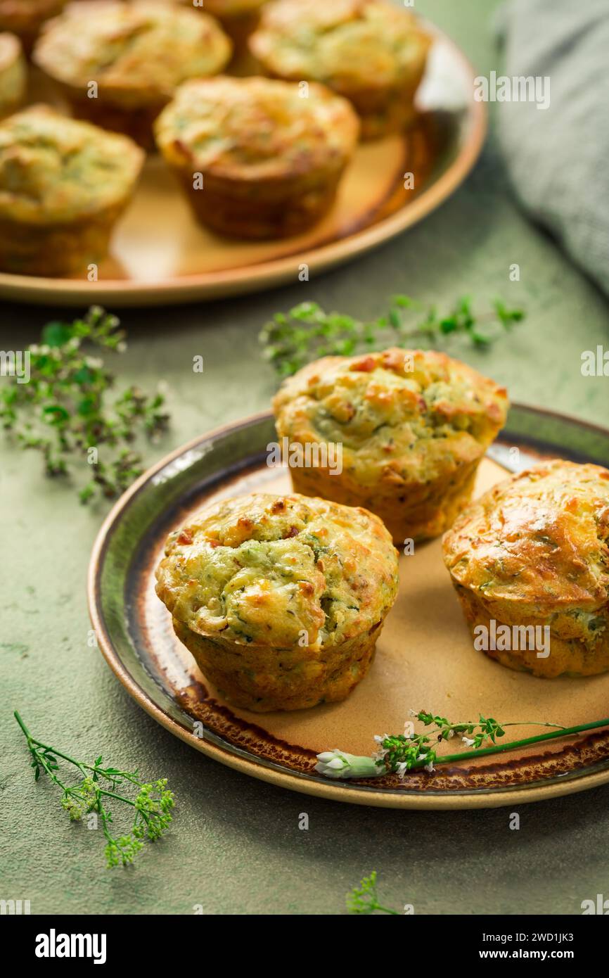 Homemade savory muffins with zucchini and cheese on kitchen table Stock ...