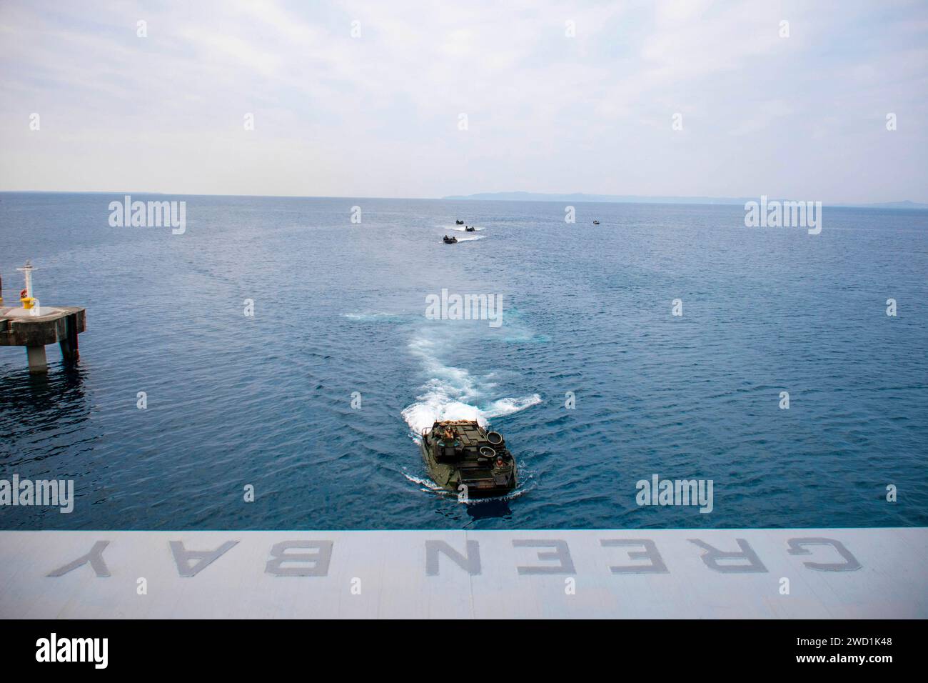 An amphibious assault vehicle prepares to embark the well deck of USS ...