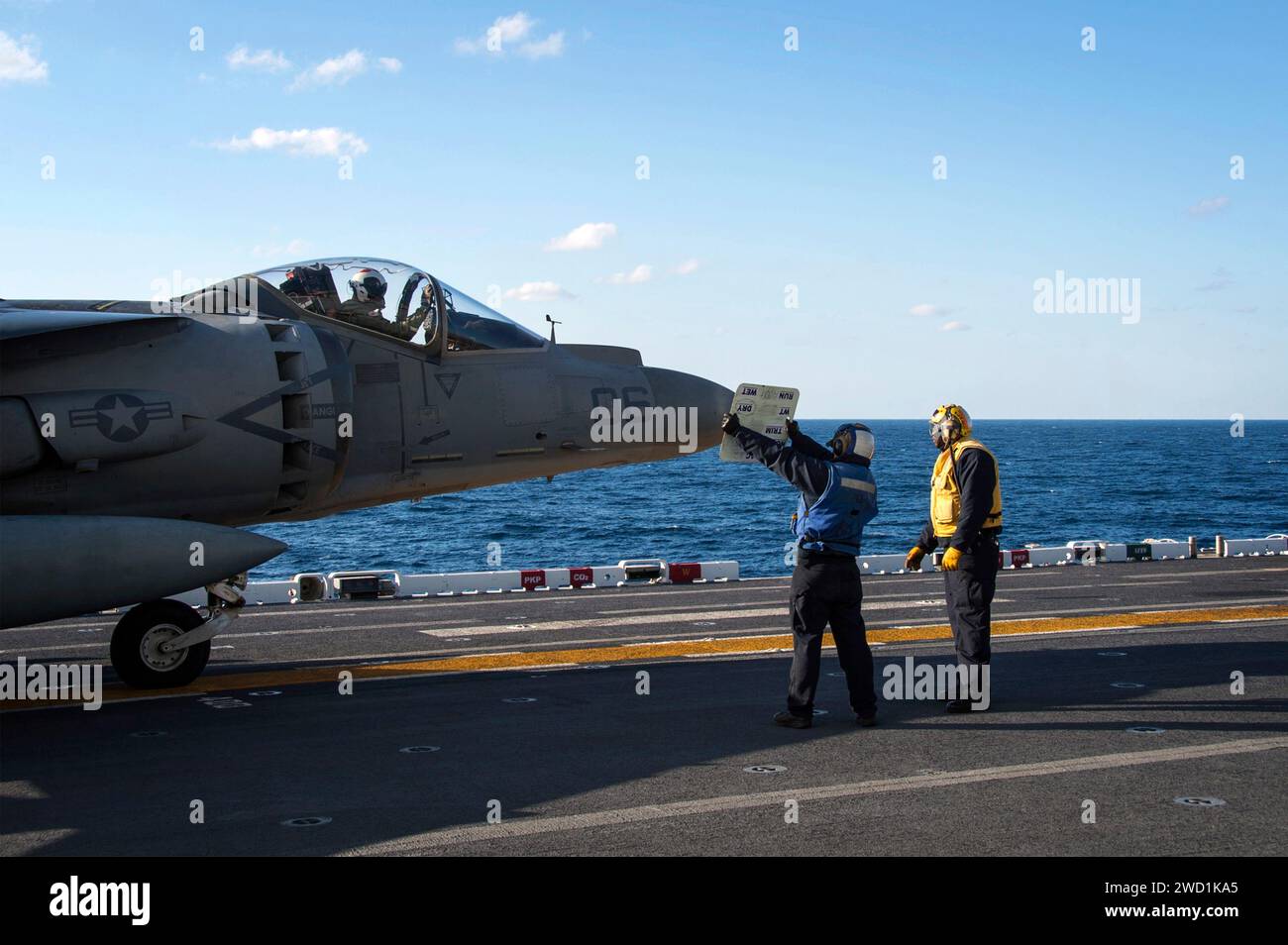 Aviation Boatswain's Mate uses a jet board to communicate with the ...