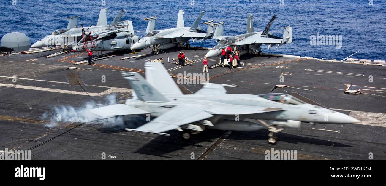 An F/A-18E Super Hornet makes an arrested landing aboard the aircraft ...