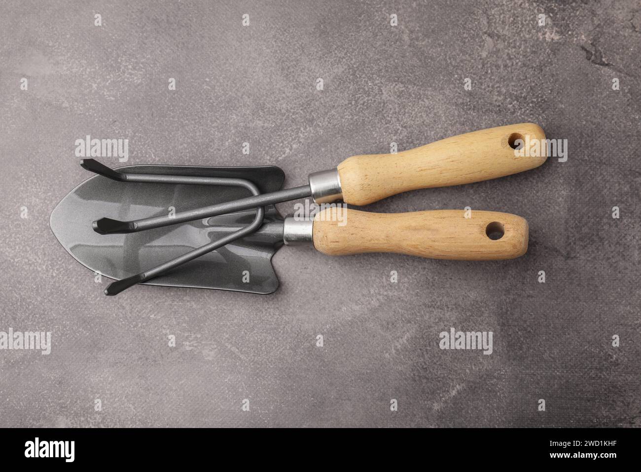 Gardening trowel and rake on brown textured table, top view Stock Photo ...