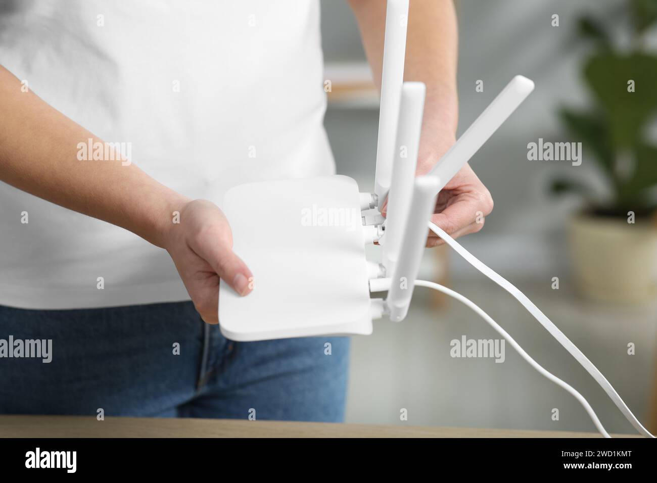 Hands ethernet cable router hi-res stock photography and images - Alamy